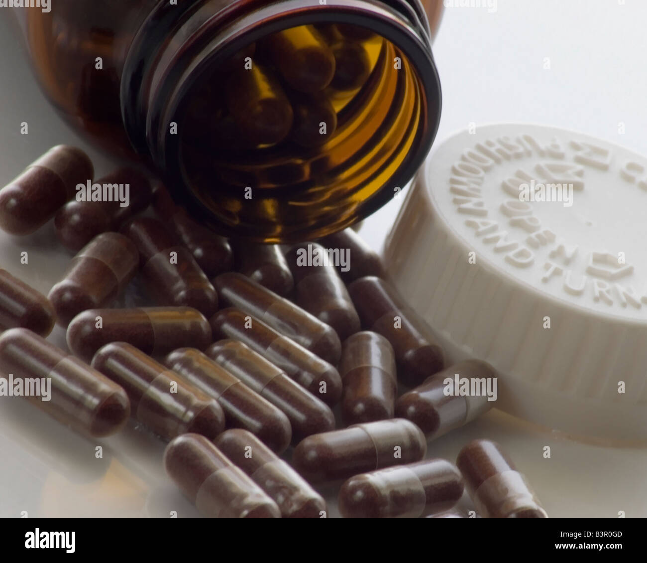 capsules falling from a pill bottle Stock Photo - Alamy