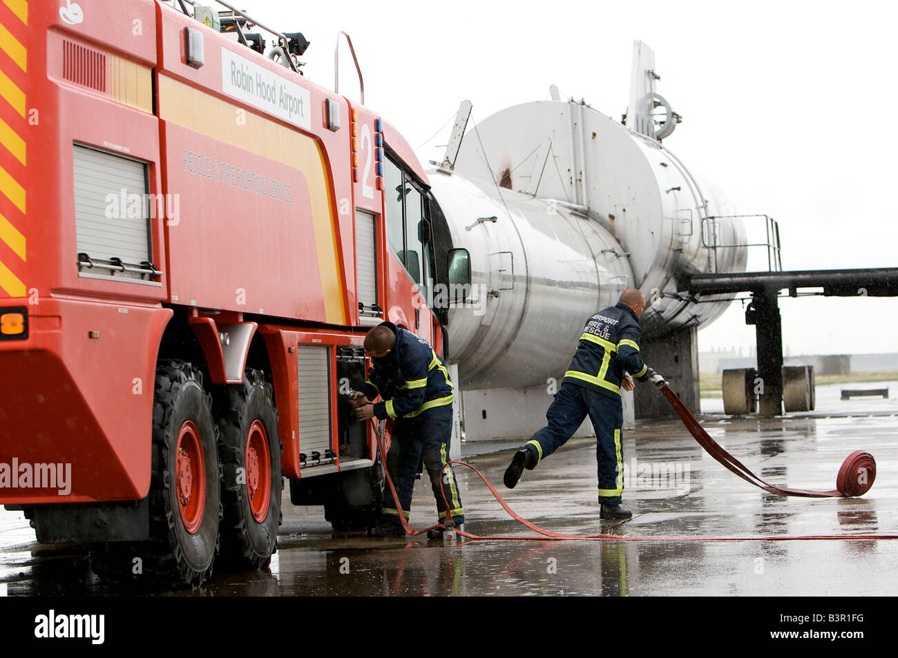 Fire fighters tackle a blaze on the training rig at Robin Hood Airport ...