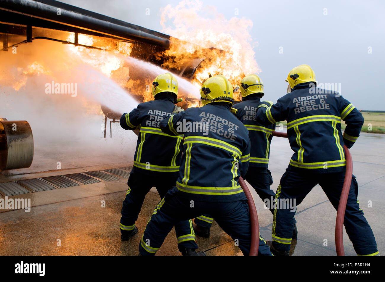 Fire fighters tackle a blaze on the training rig at Robin Hood Airport ...