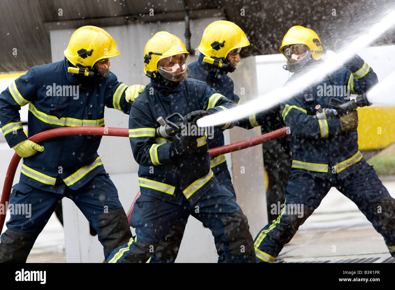 Fire fighters tackle a blaze on the training rig at Robin Hood Airport ...