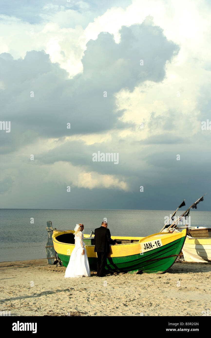 Newly wed couple having a photo session on a beach of Jantar village ...