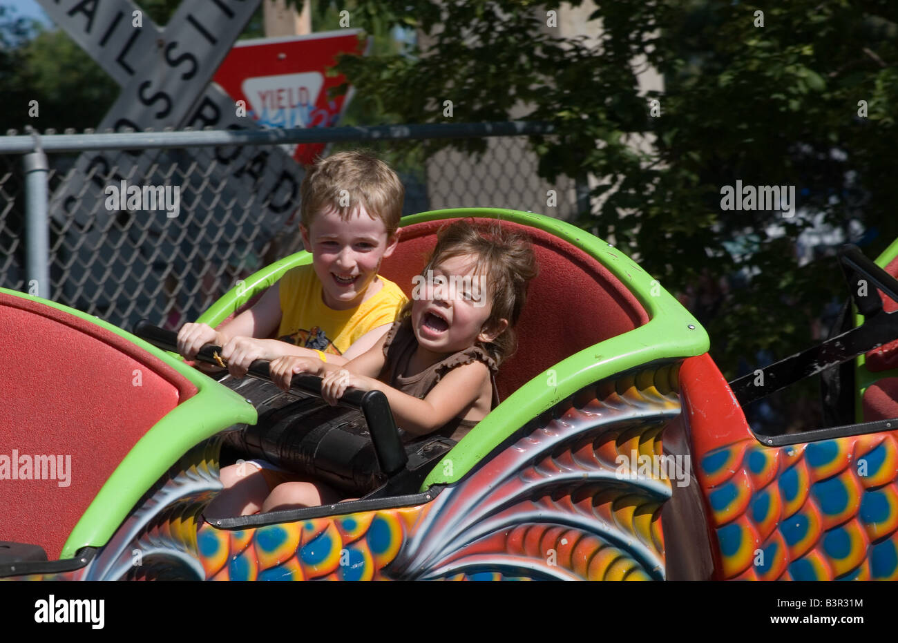 2 children having fun on a roller coaster Stock Photo - Alamy