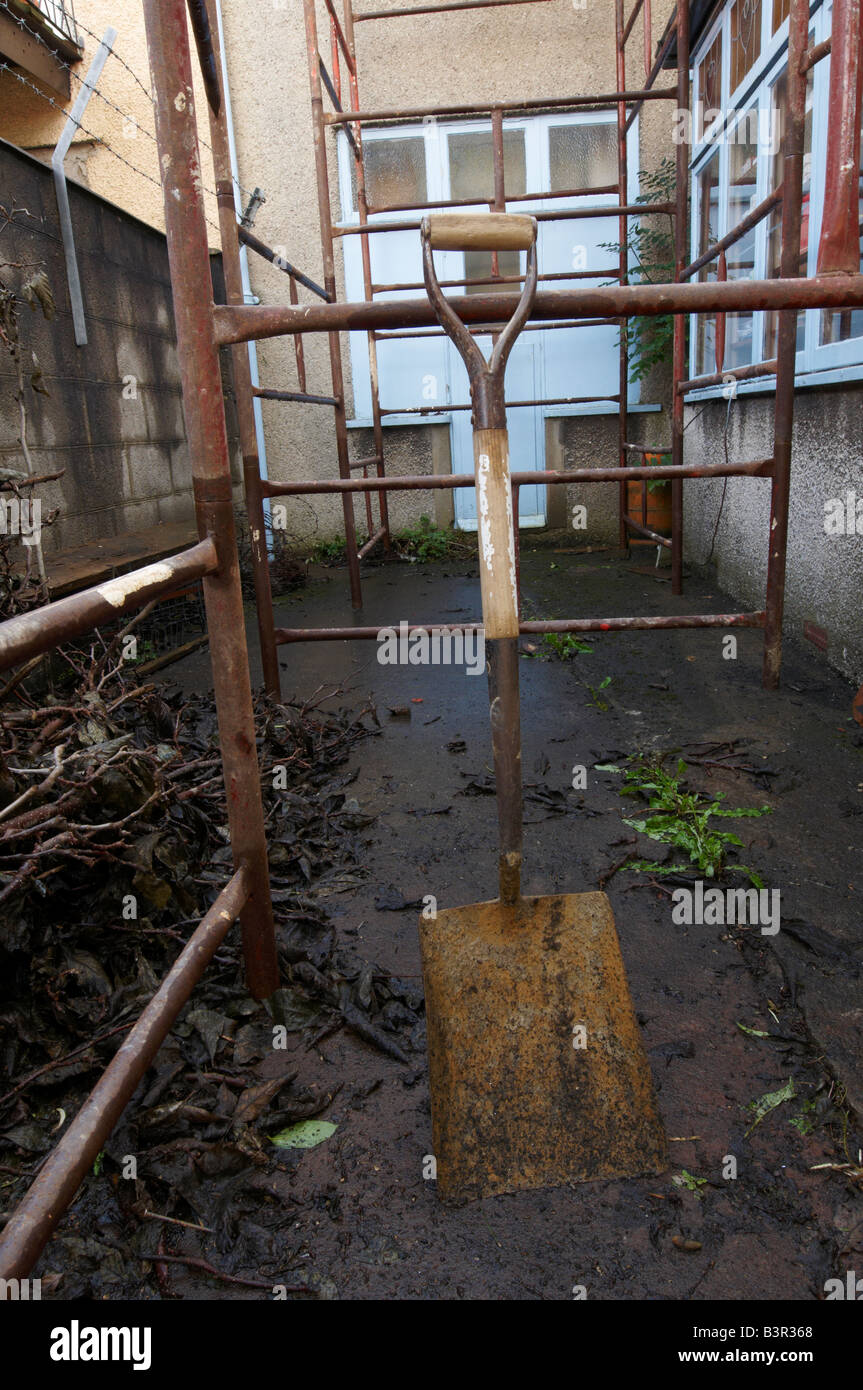 Scaffolding in back garden for building work with spade Stock Photo - Alamy