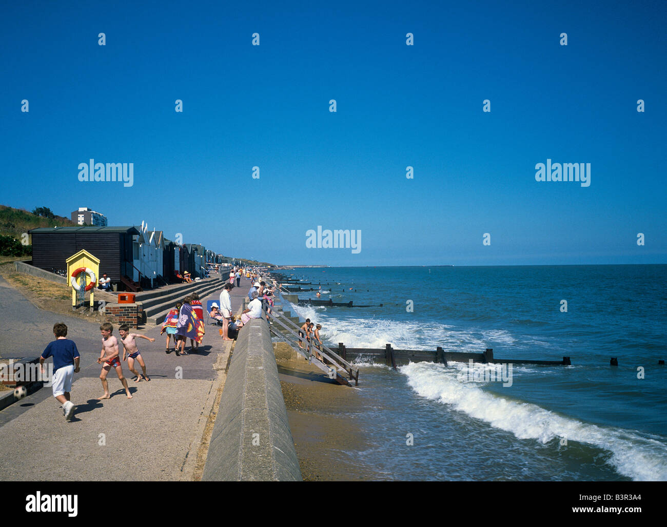 Frinton beach huts behind the promenade along the beach looking East ...