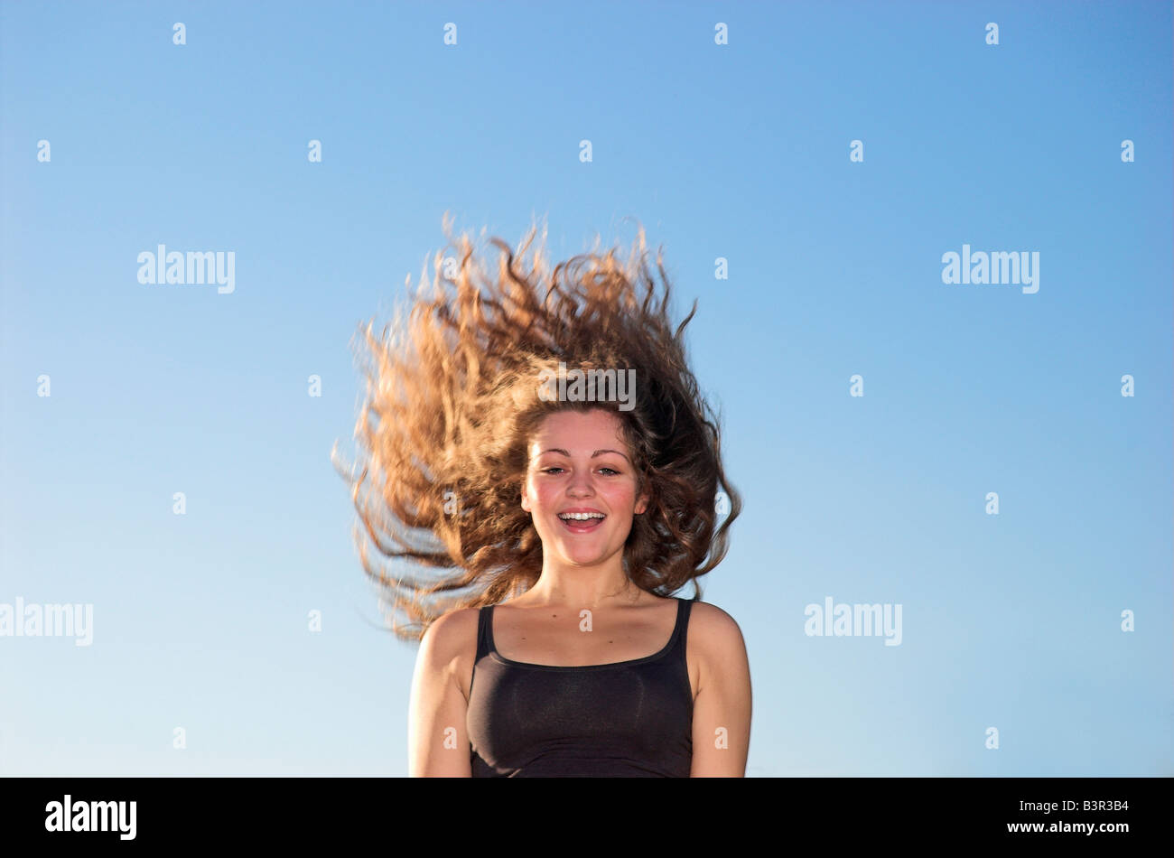 Teenage girl 16 18 with long hair tossing head back portrait Stock ...