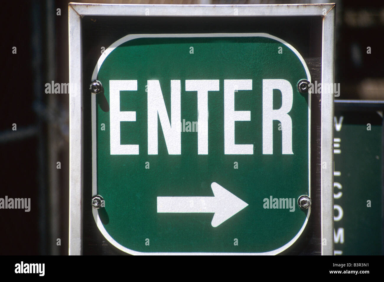 Sign with word "enter" and direction arrow in white on green background ...