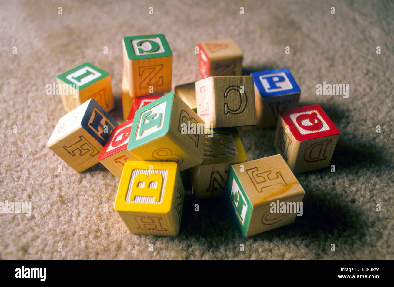 Pile of child's toy blocks on carpet Stock Photo - Alamy