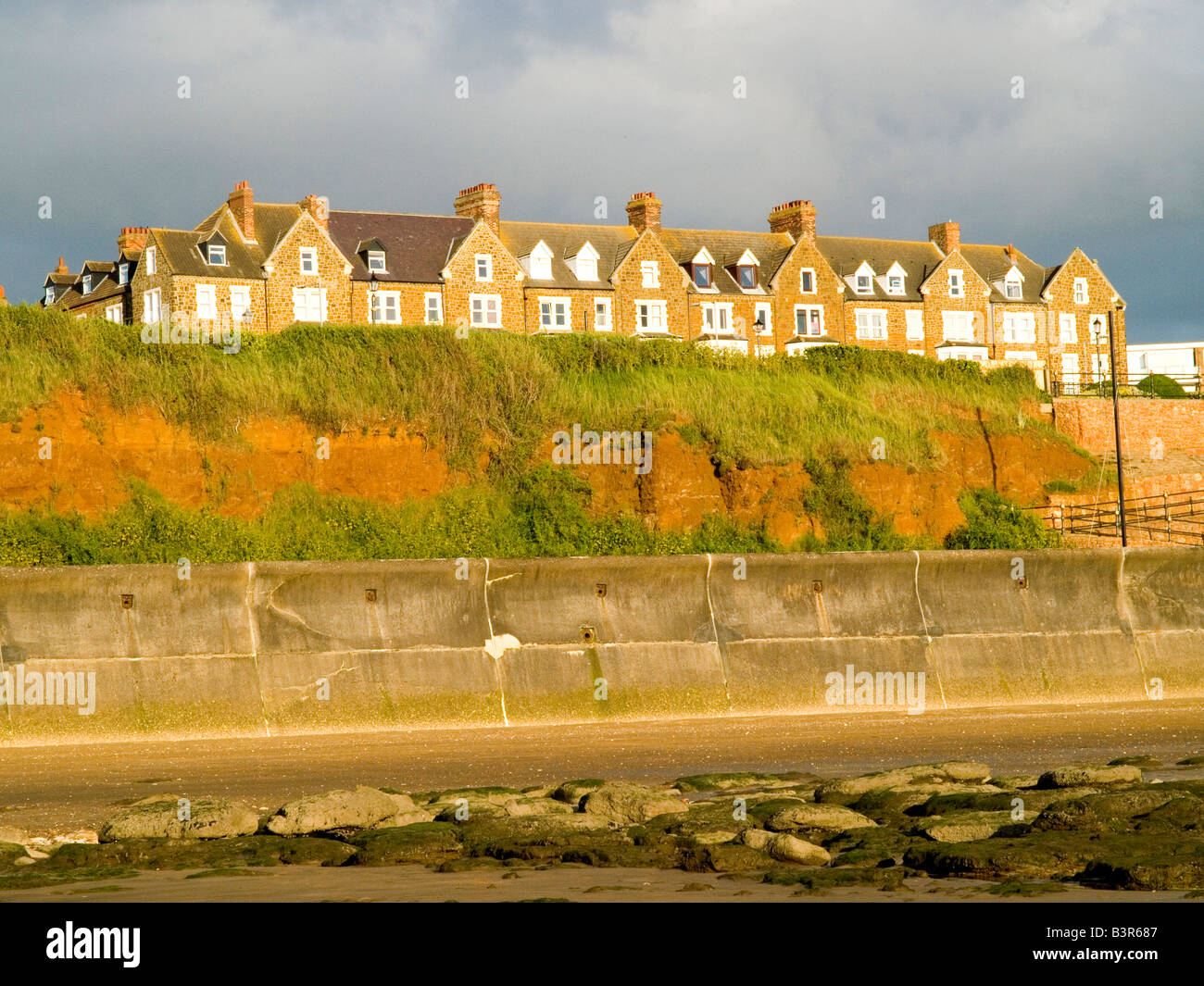 A line of houses high above the beach at sunset in Hunstanton, Norfolk ...