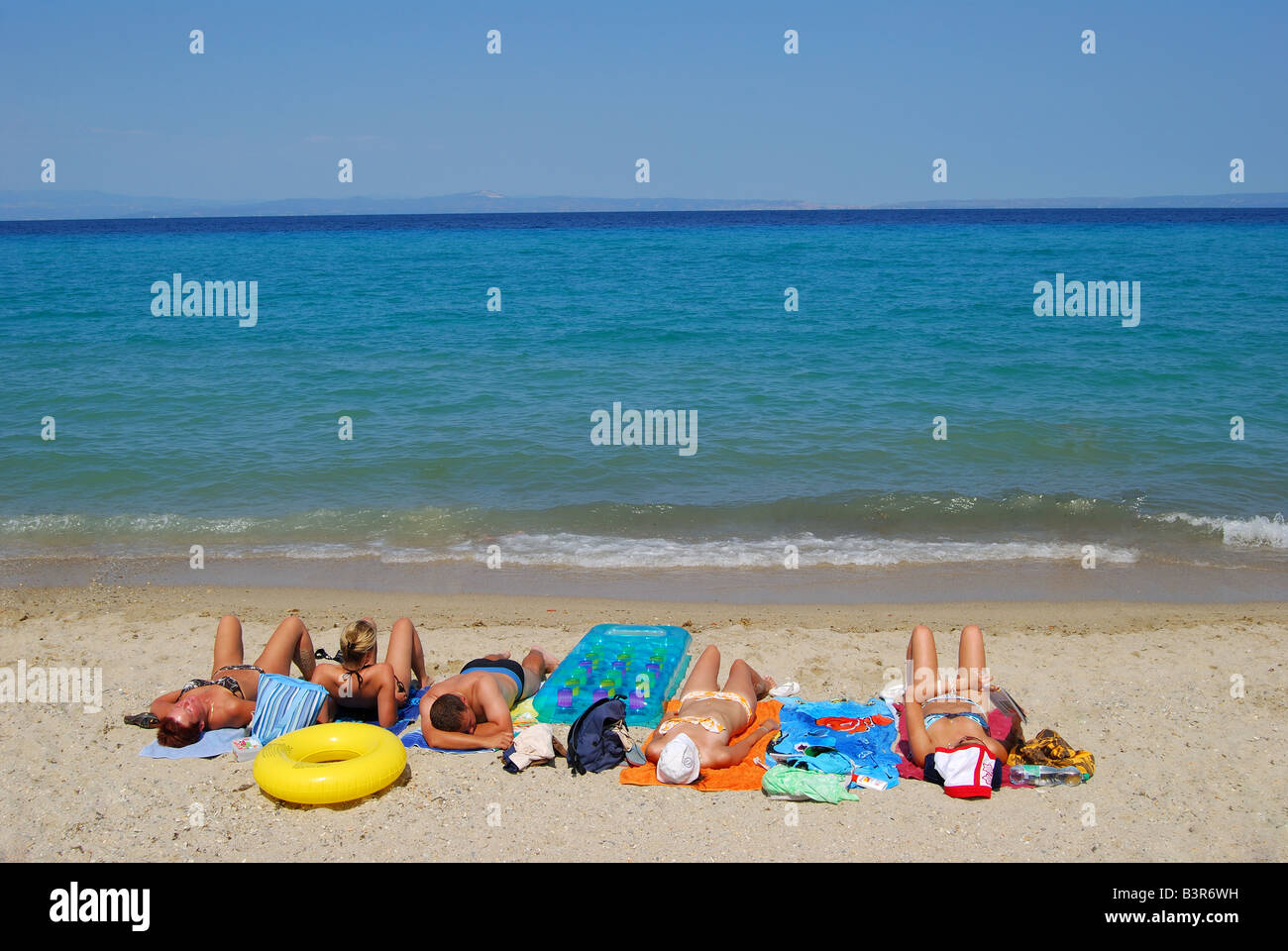 Group on beach, Polychrono, Kassandra Peninsula, Chalkidiki, Central ...