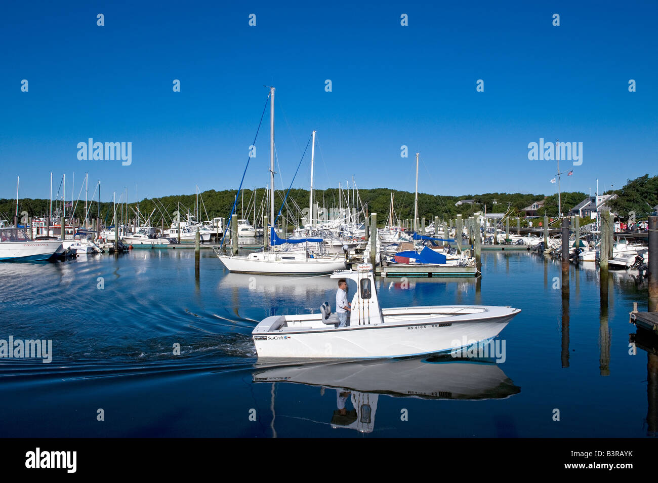 Small boat preparing top dock in Saquatucket Harbor Harwich Cape Cod MA ...