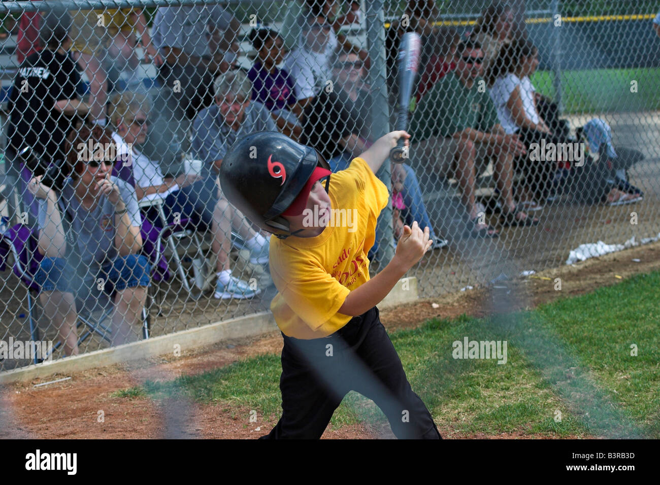A youngster connects with the baseball in coach-pitch little league ...