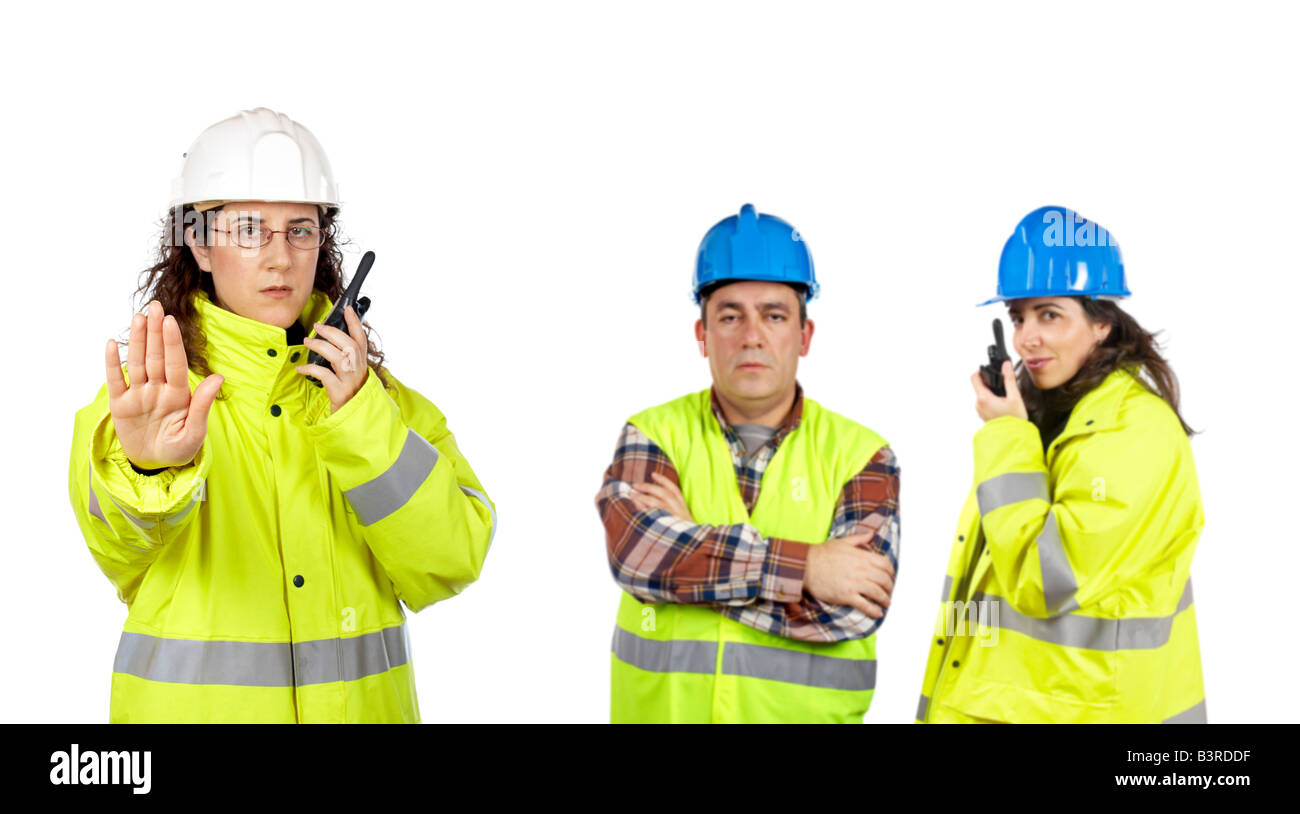Three construction workers talking with a walkie talkie over a white ...