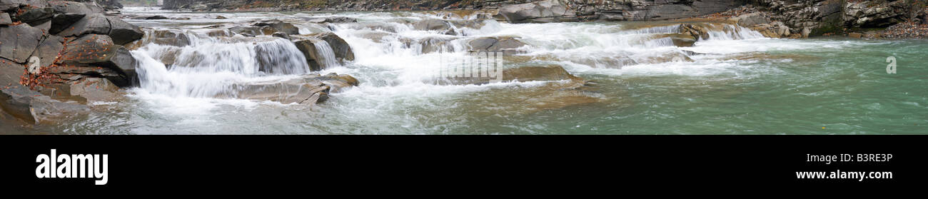 Panorama view of autumn mountain river with waterfall. Six shots ...