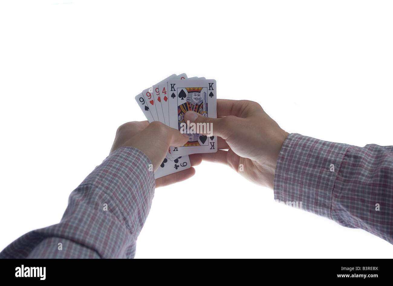 man cheating while playing poker Stock Photo - Alamy