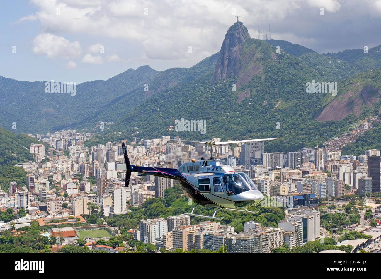 A tourist helicopter in flight around Rio with Corcovado mountain and ...