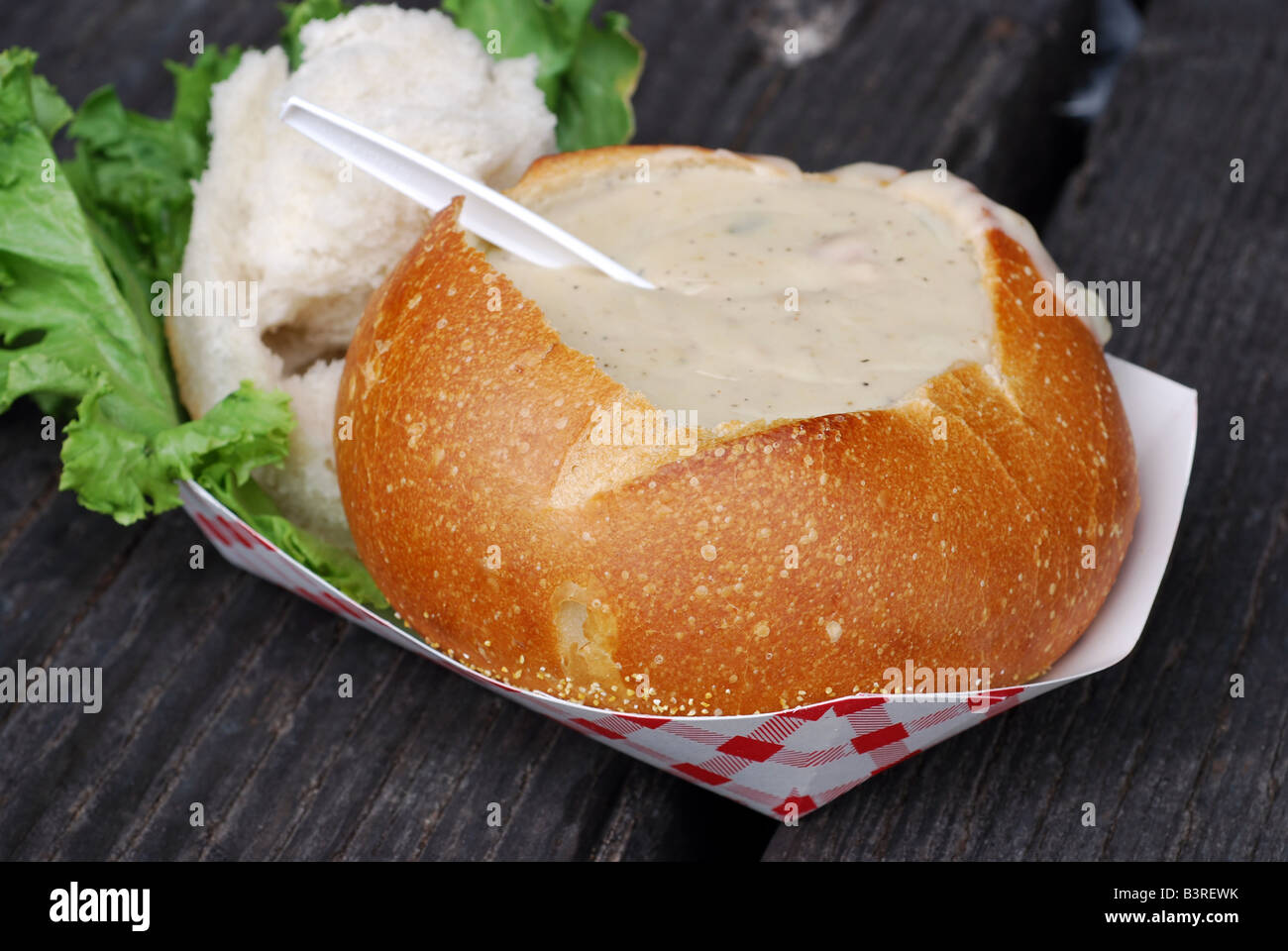 Clam chowder in a sourdough bread bowl on a wooden fishing dock Stock ...