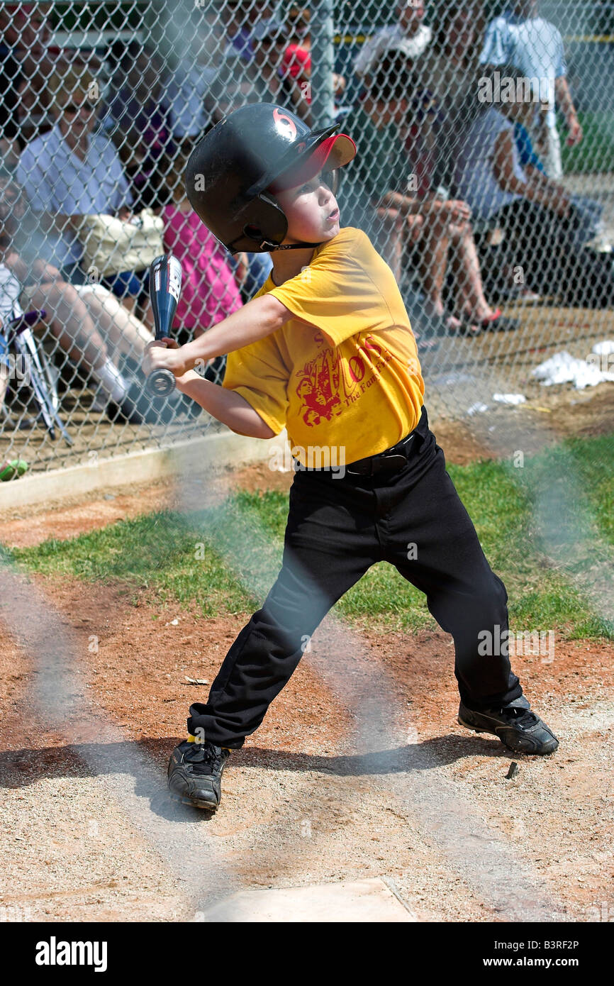 A youngster connects with the baseball in coach-pitch little league ...