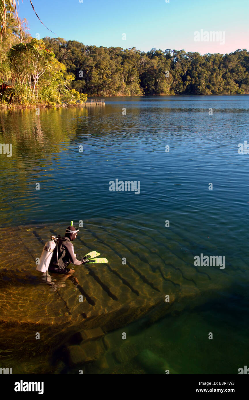 Scuba diver entering the clear waters of Lake Eacham Crater Lakes ...