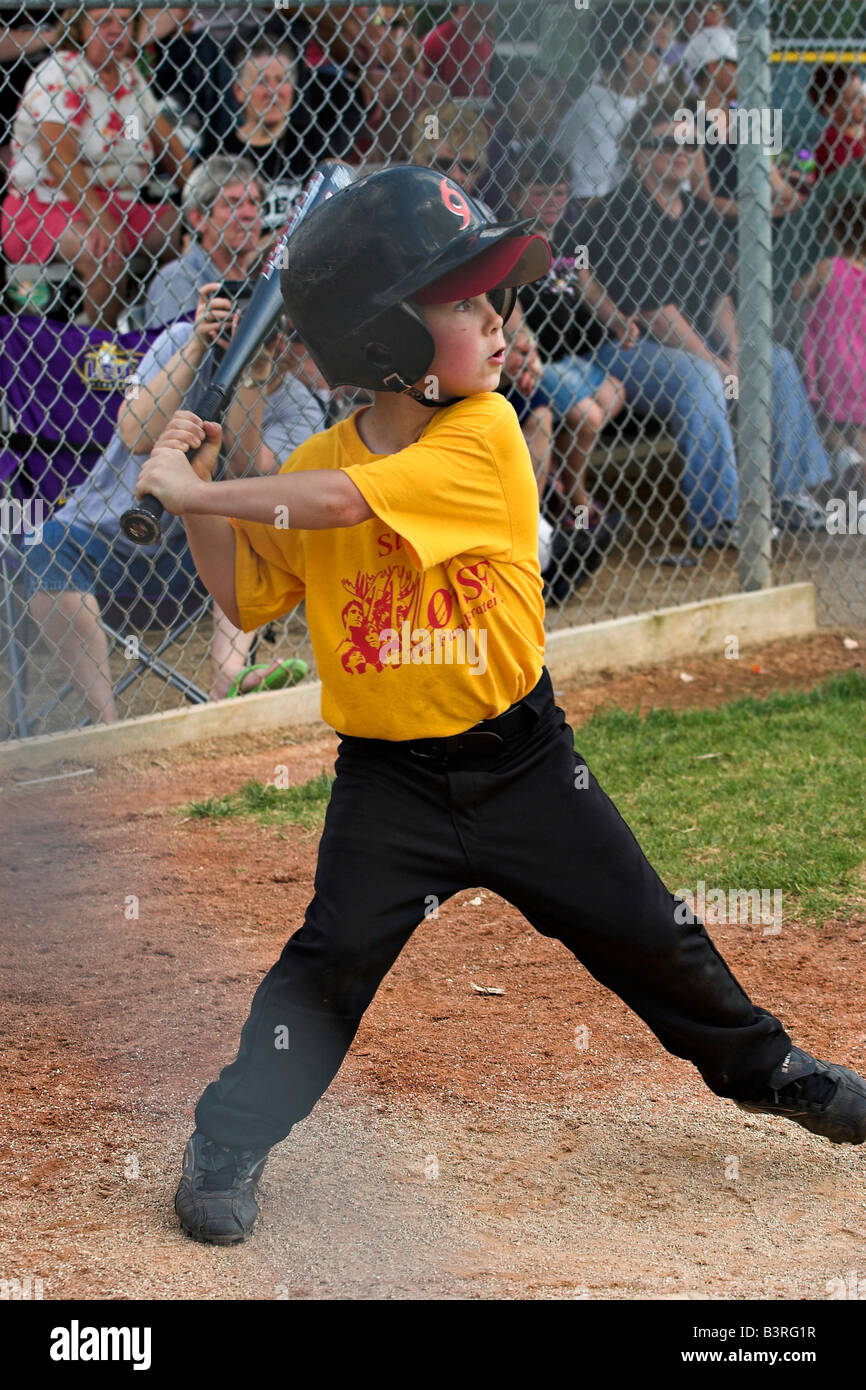 A youngster connects with the baseball in coach-pitch little league ...