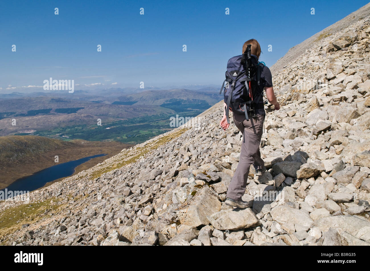 Single female hiker hikes rocky normal route trail towards summit of ...