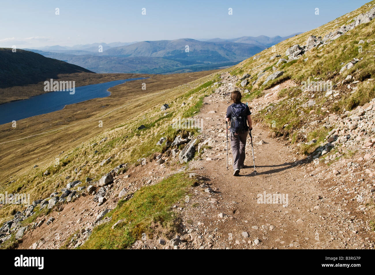 Single female hiker hikes normal route trail towards summit of Ben ...