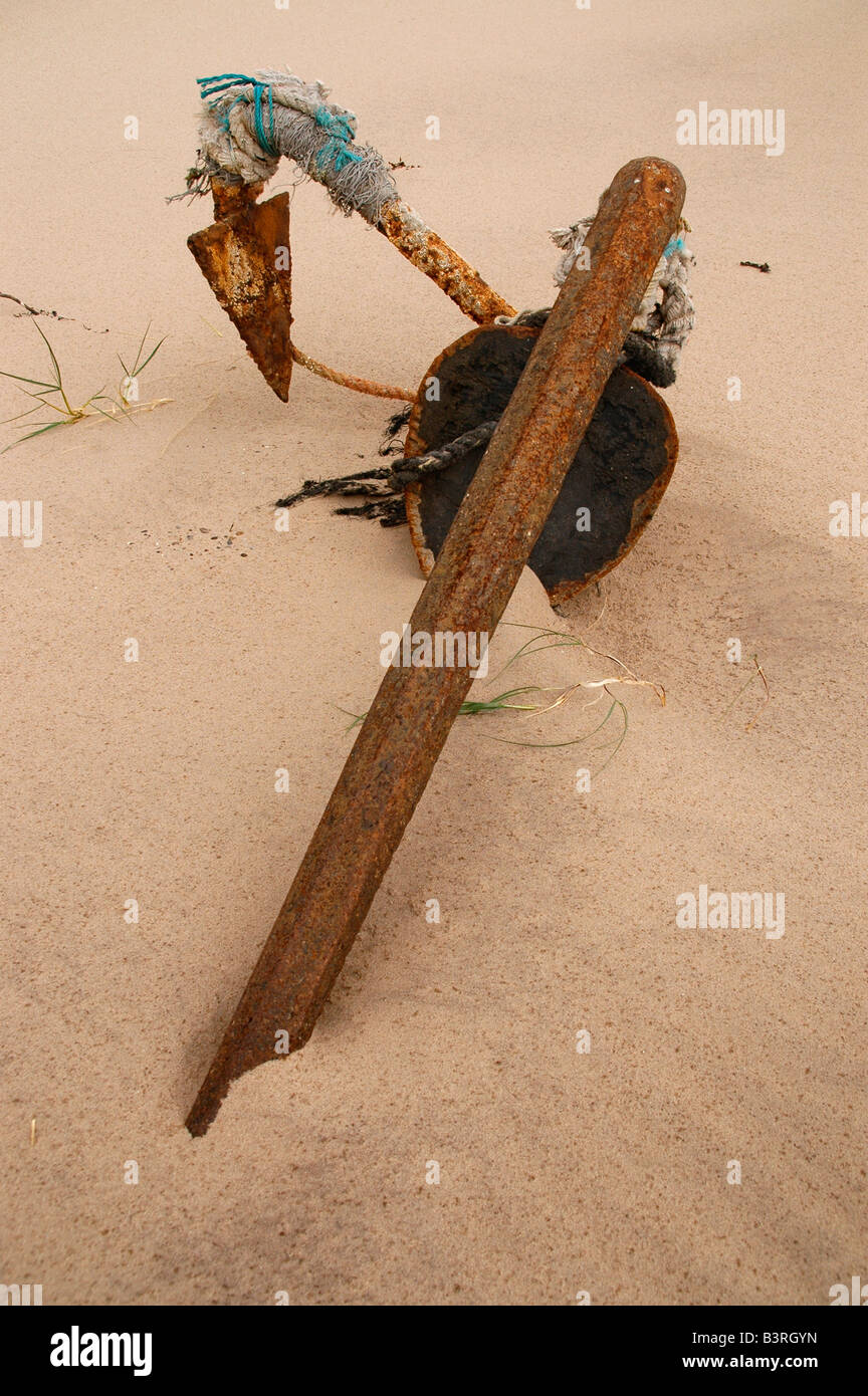 A rusty anchor lies in sand Stock Photo - Alamy