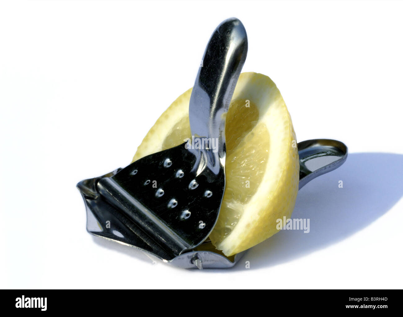 Lemon Slice in Squeezer Stock Photo - Alamy