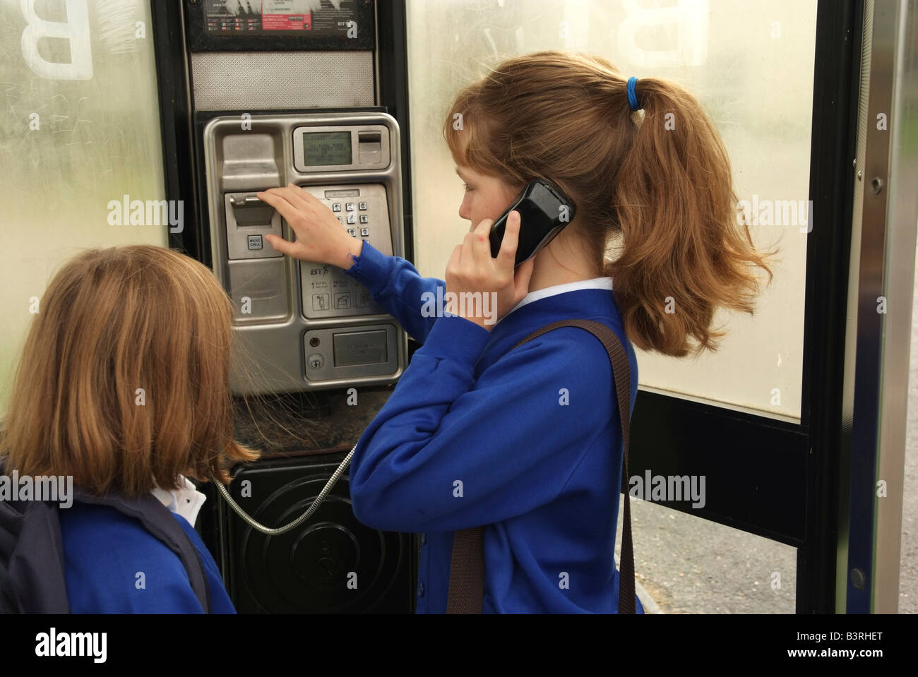 Girl calling from telephone booth hi-res stock photography and images ...