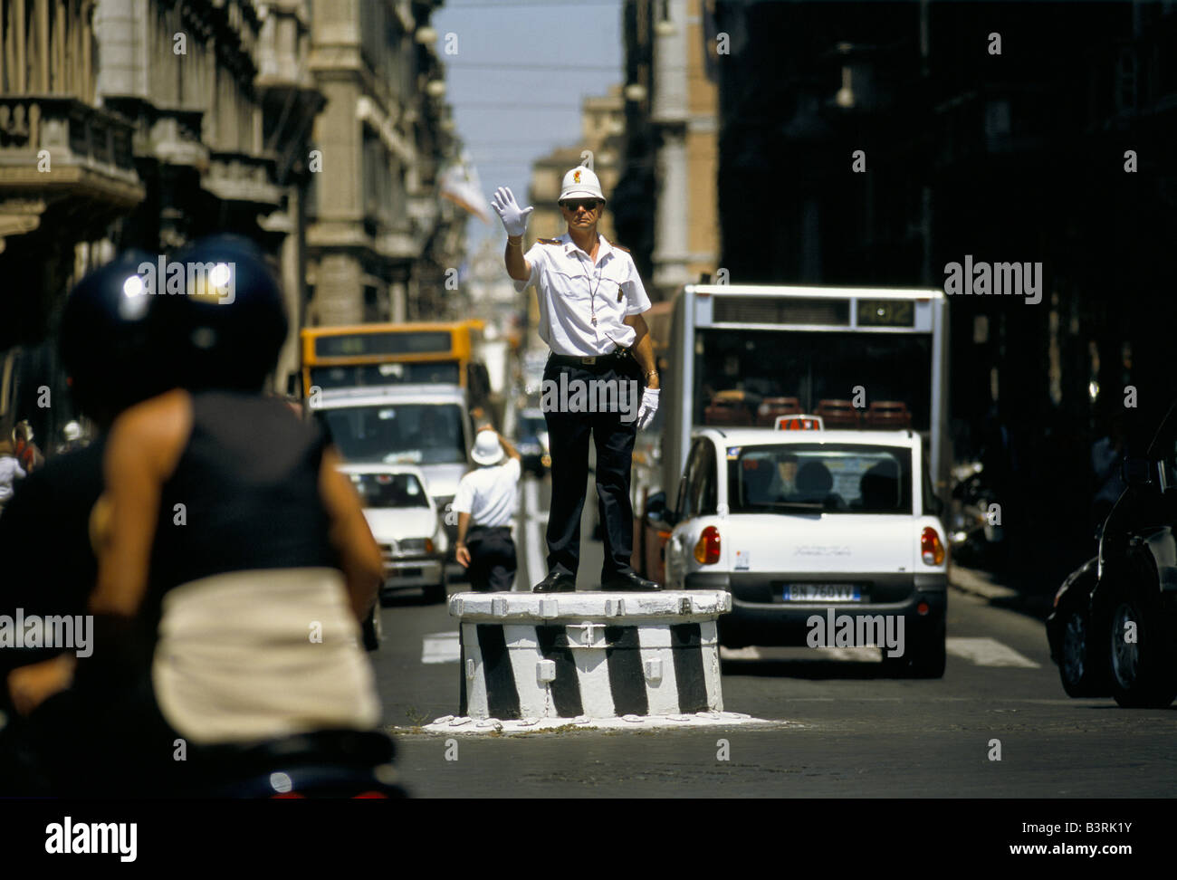 Policeman directing traffic during the rush hour in the centre of Rome ...