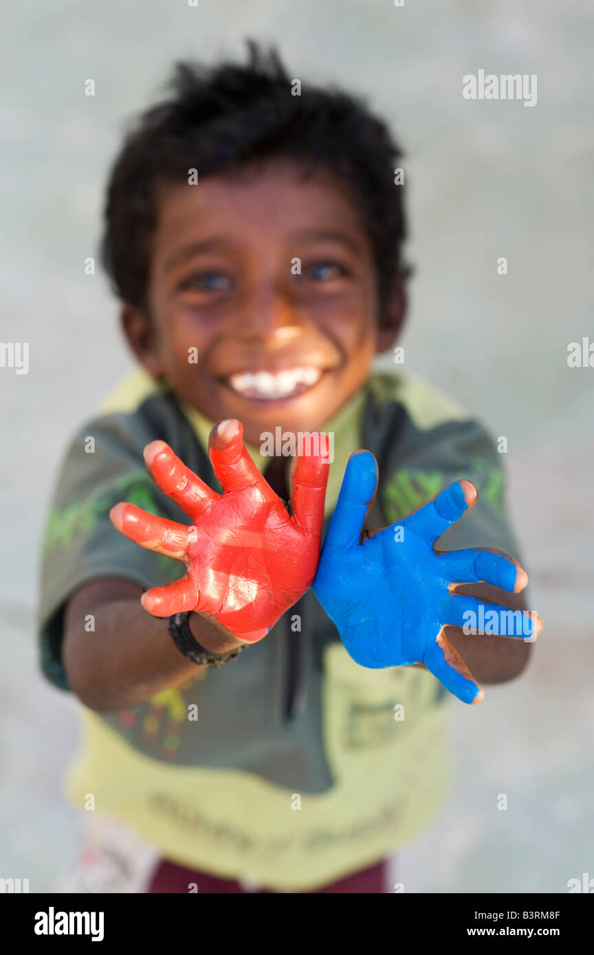 Indian boy with blue red painted hands Stock Photo - Alamy