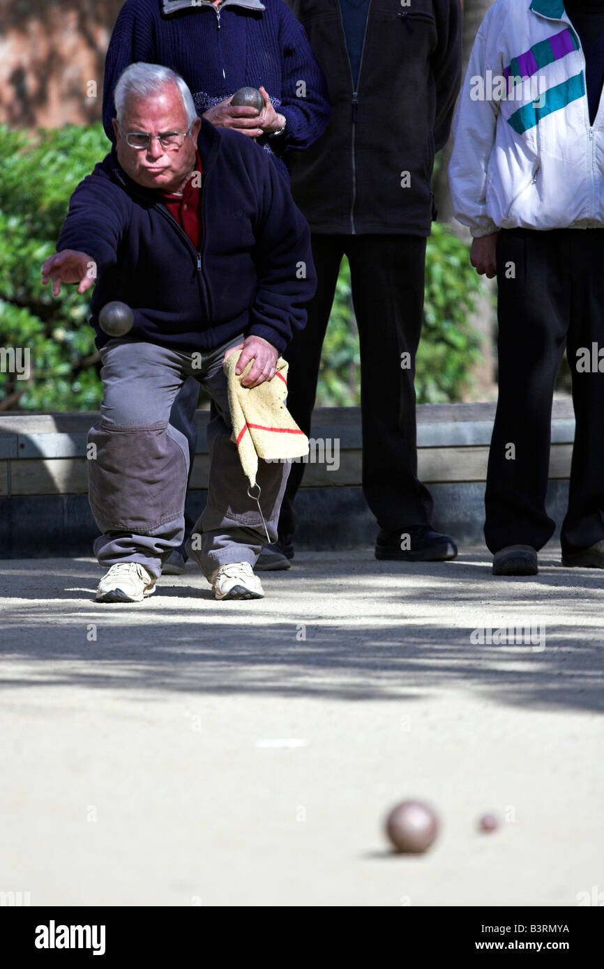 Several older gentleman play Bocce in a public courtyard in Barcelona ...