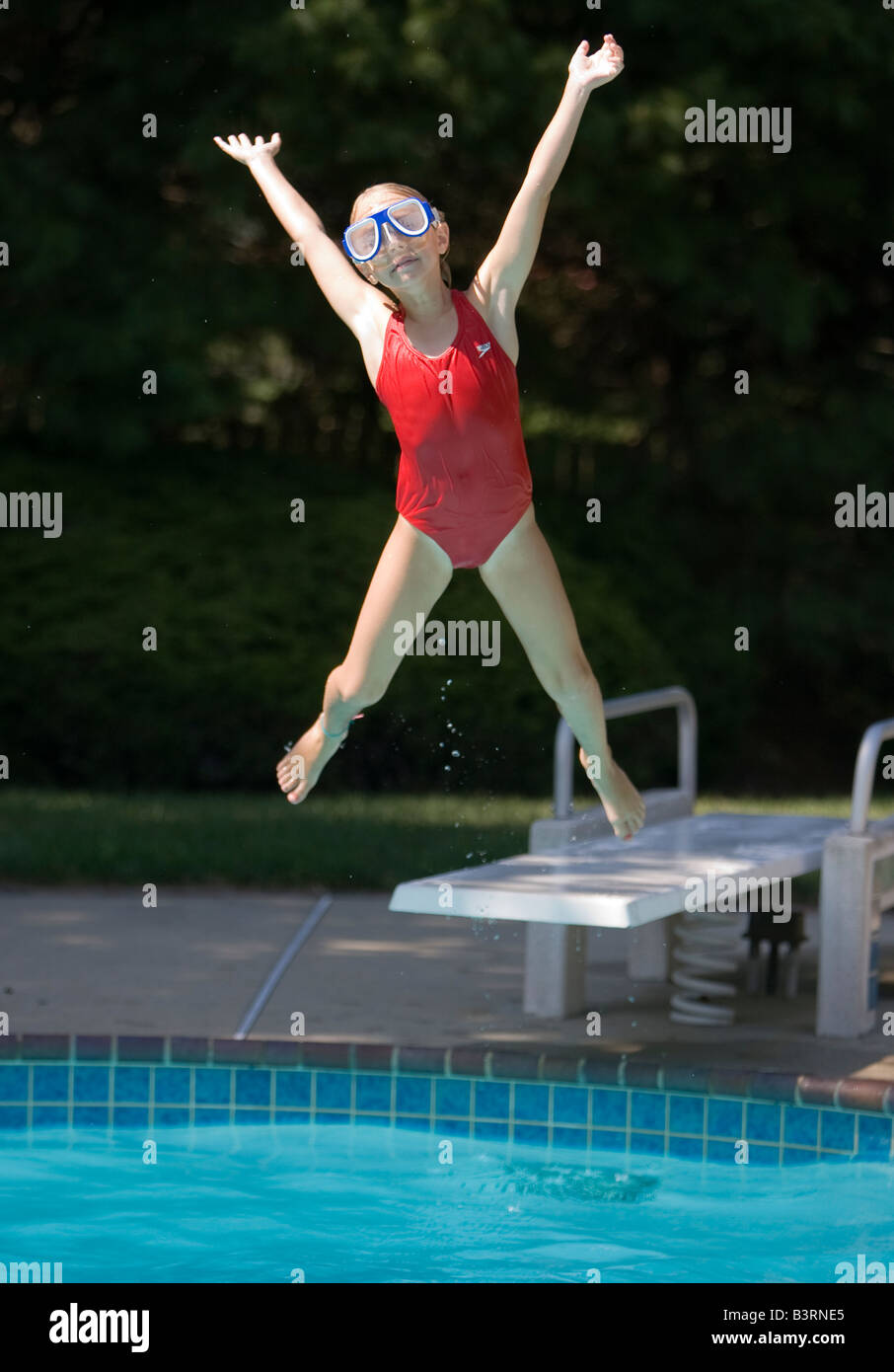 Child jumping into a backyard swimming pool Stock Photo - Alamy