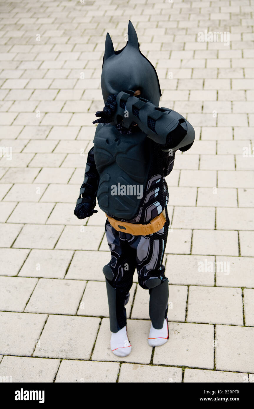 Portraits of young four year old boy dressed up in Batman suit posing ...