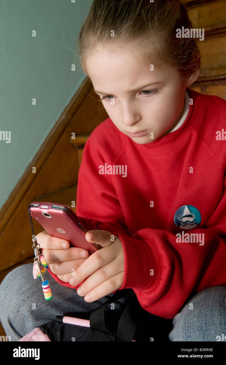 ten year old girl child texting her friends on her mobile cell phone ...