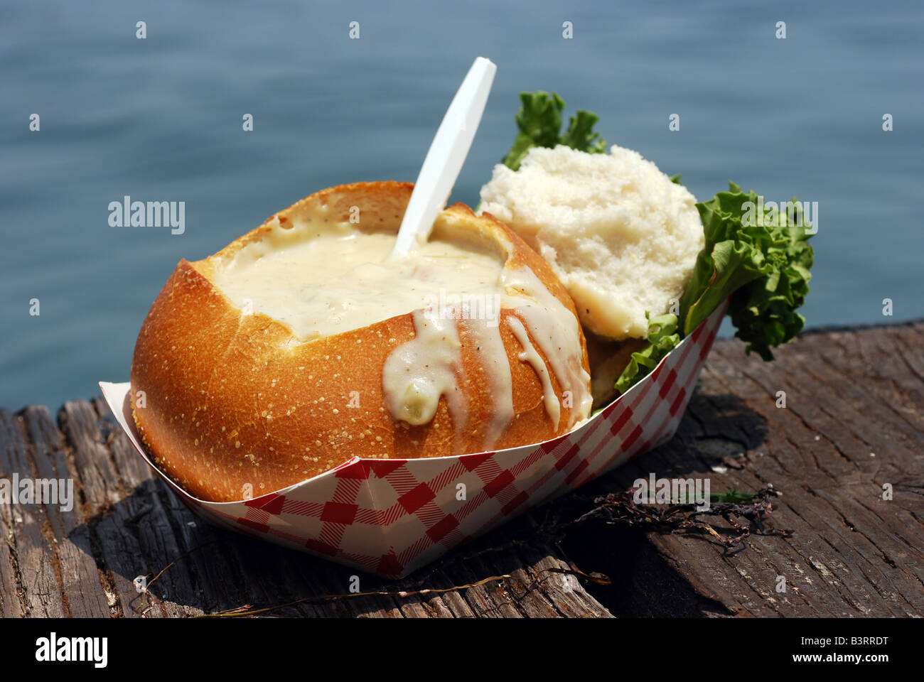 Clam chowder in a sourdough bread bowl on a wooden fishing dock Stock ...