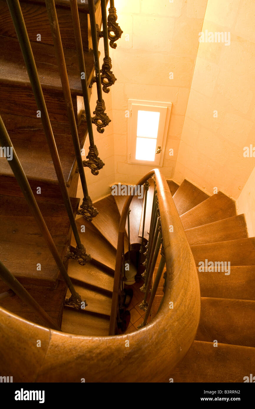 looking down the winding steps of an original circular stairwell in a ...