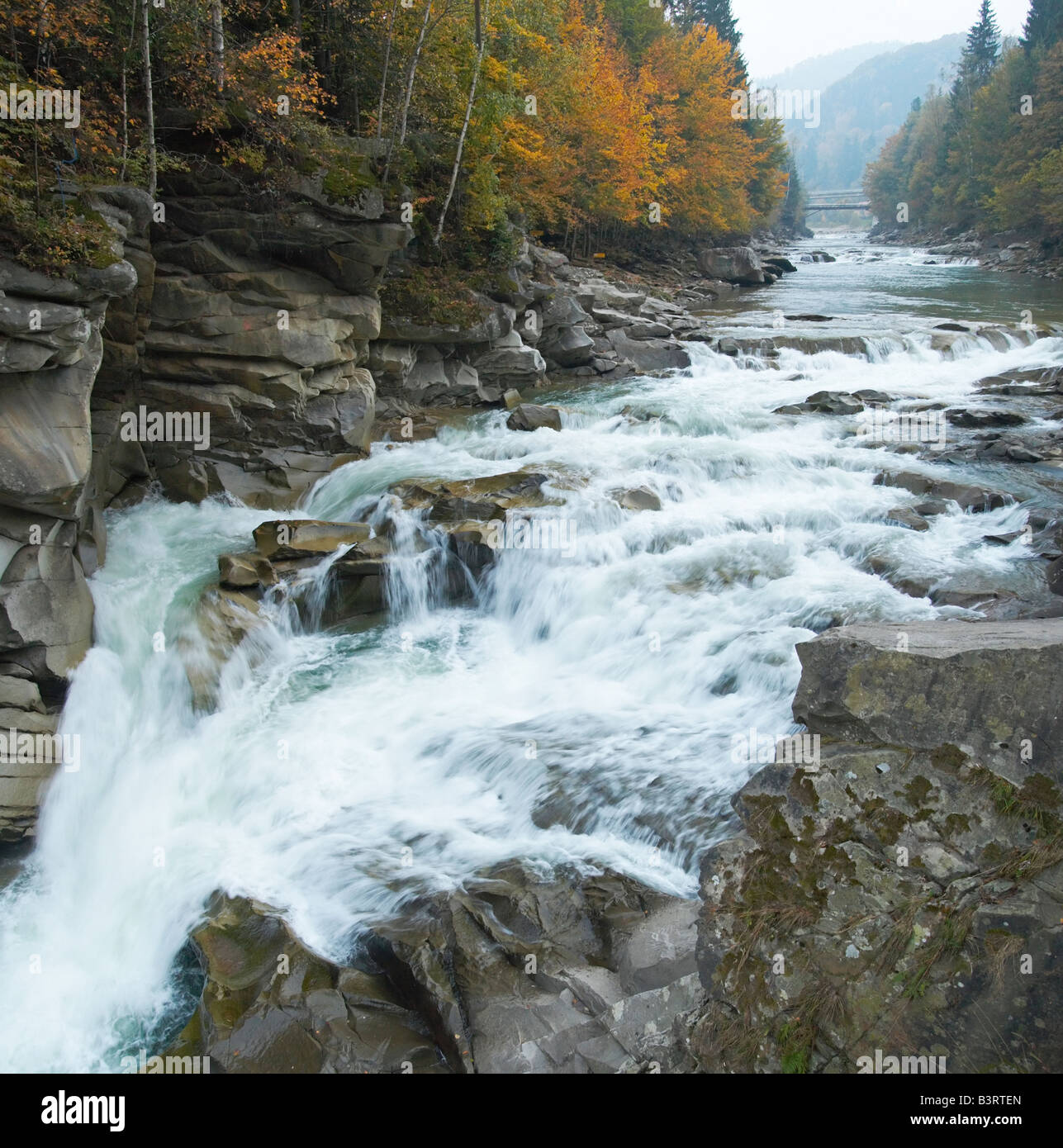 Autumn mountain river view with waterfall and bridge (Ukraine, Jaremcha ...