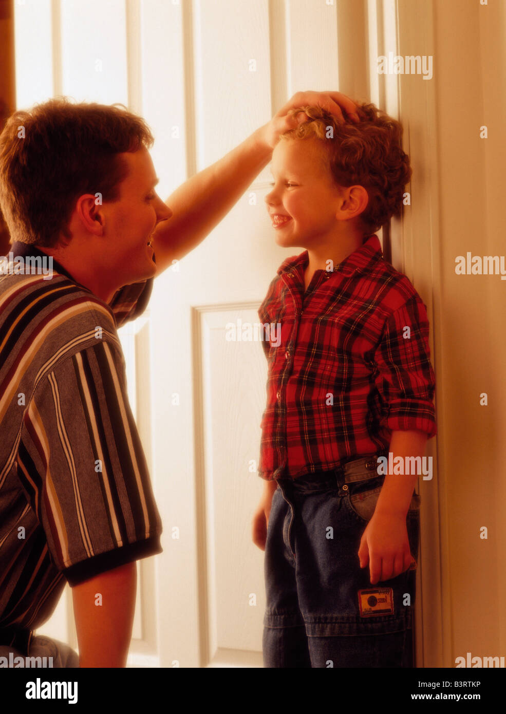 Father and son looking in eyes and smiling Stock Photo - Alamy