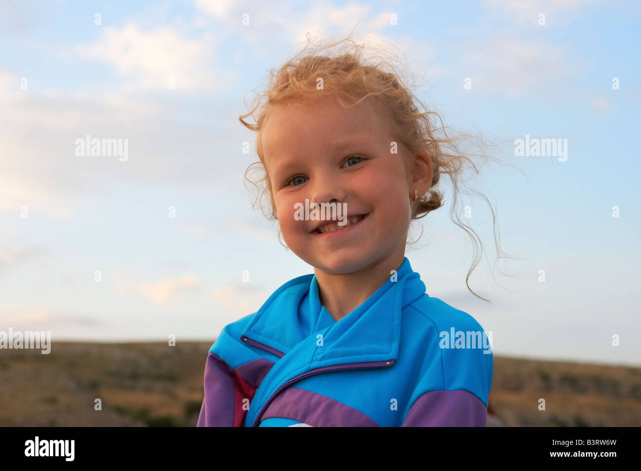 Small smiling girl outdoor portrait Stock Photo - Alamy