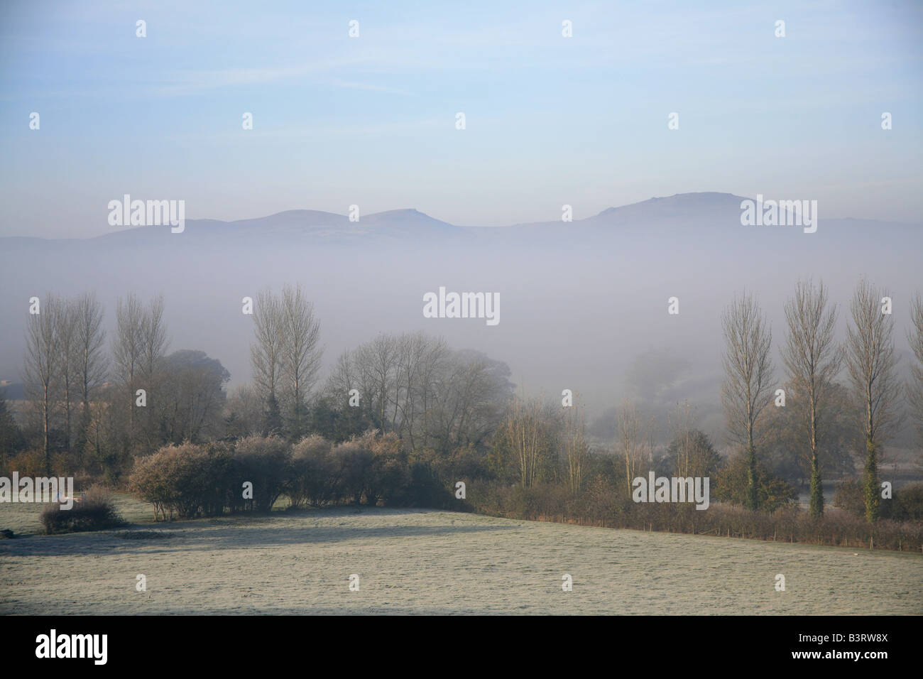 Long Mynd and fields on misty winter morning Stock Photo - Alamy
