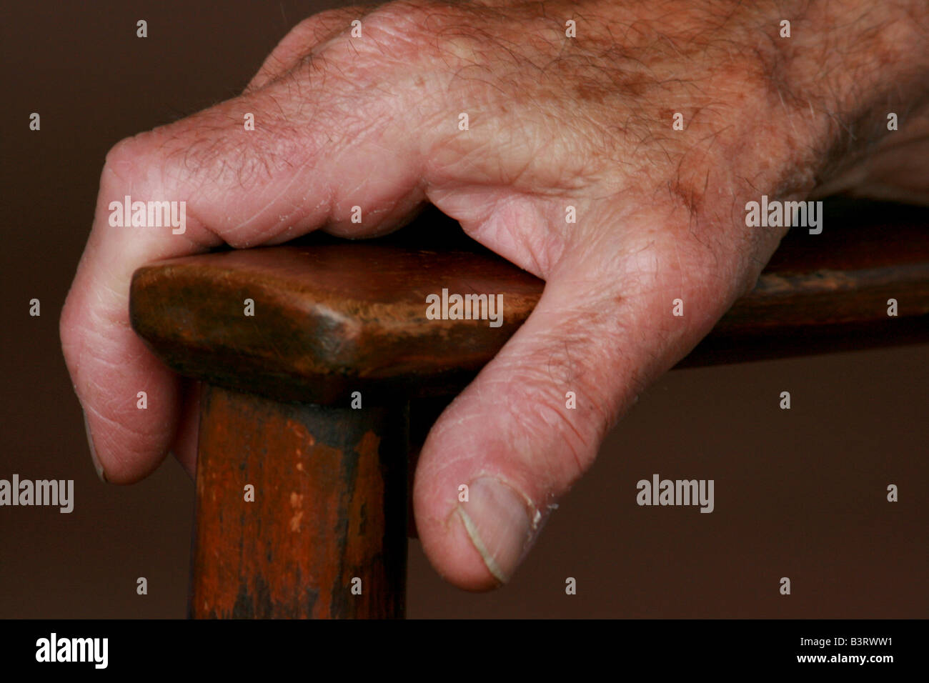 An old man holding the chair Stock Photo - Alamy