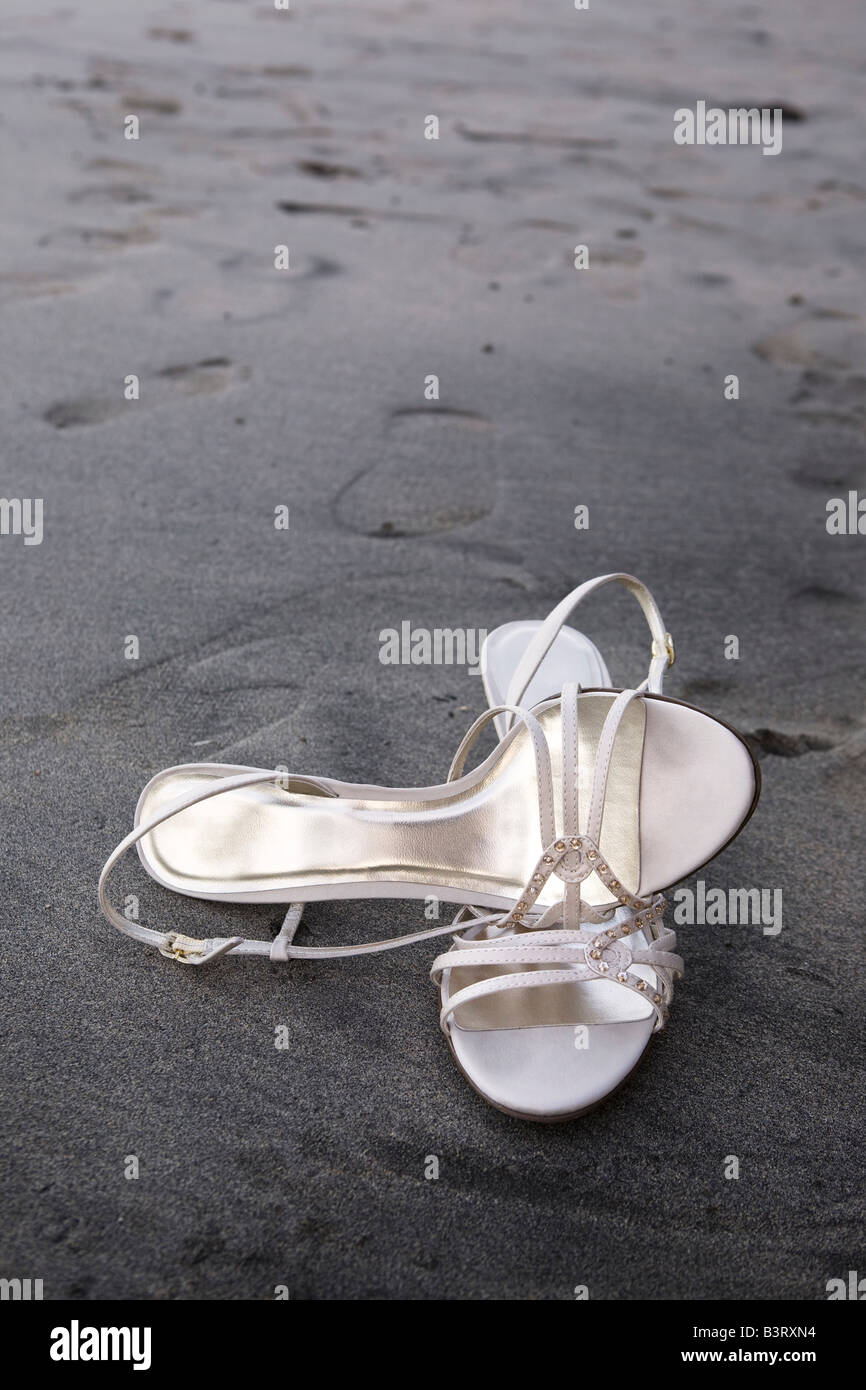 High heel sandals on wet sand Stock Photo - Alamy