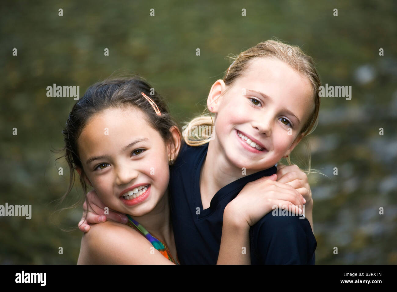 Portrait of two girls hugging Stock Photo - Alamy