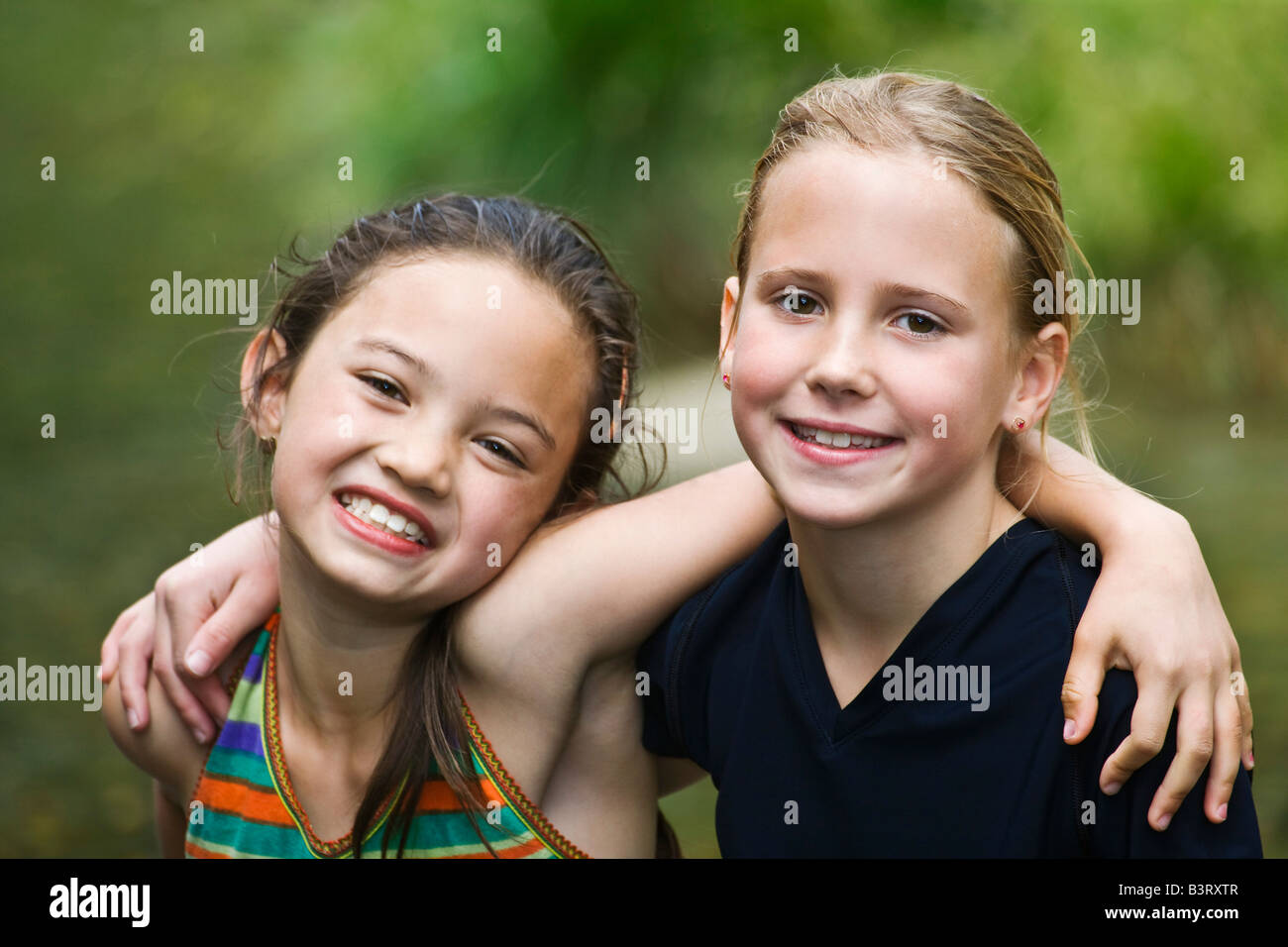 Portrait of two girls hugging Stock Photo - Alamy