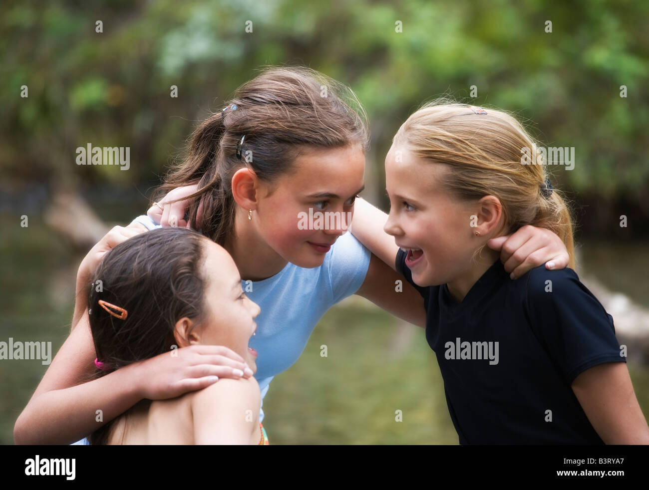 Three girls talking Stock Photo - Alamy