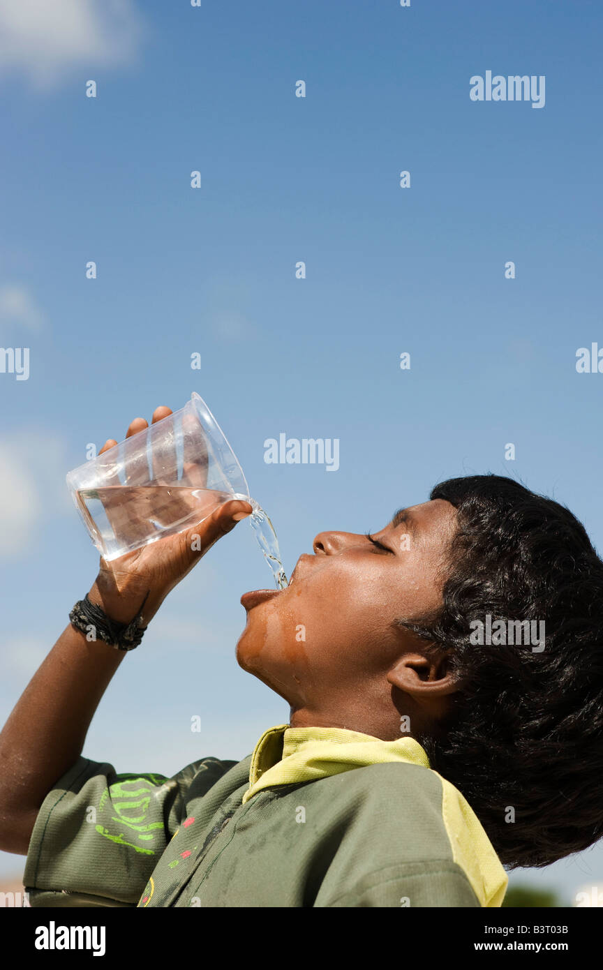 Indian boy drinking water from plastic cup. India Stock Photo - Alamy