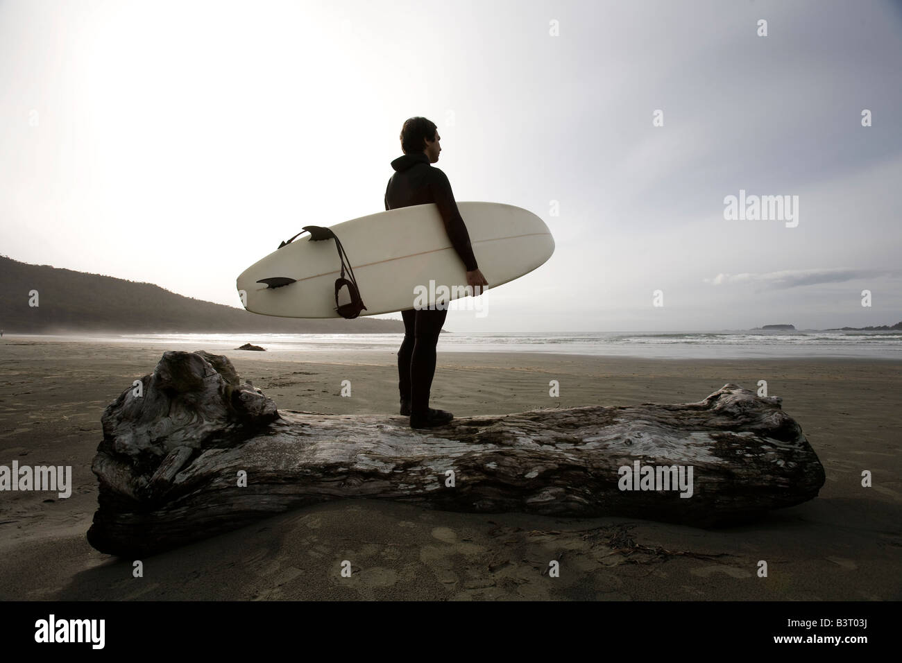Surfer on beach Stock Photo - Alamy