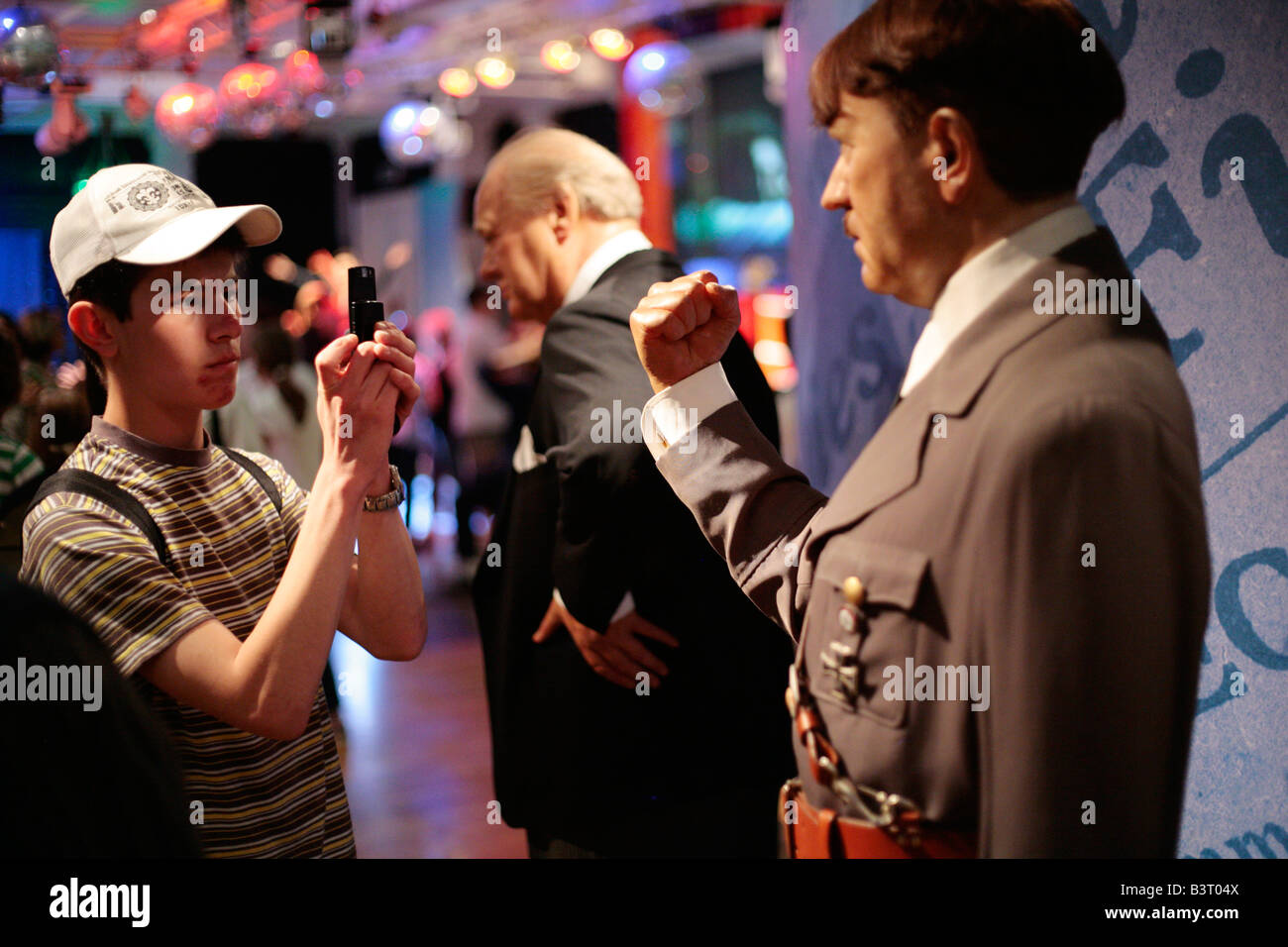 teenage boy taking a picture of the wax figure of Hitler at Madame ...