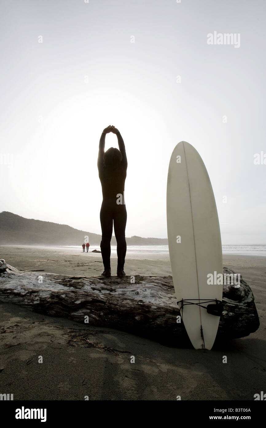 Surfer stretching on beach Stock Photo - Alamy