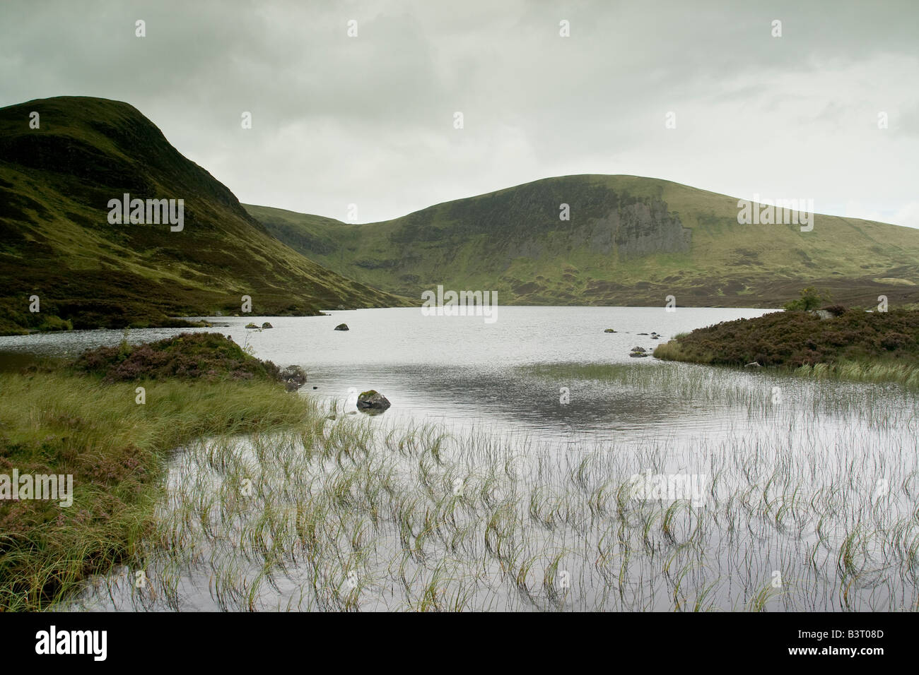 A Scottish loch in a hanging valley surrounded by mountains Stock Photo ...